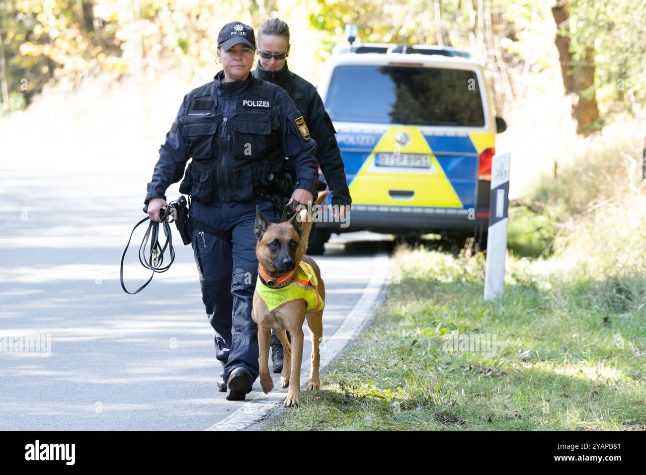 15 October 2024, Saxony, Annaberg-Buchholz: Policewomen walk with a ...