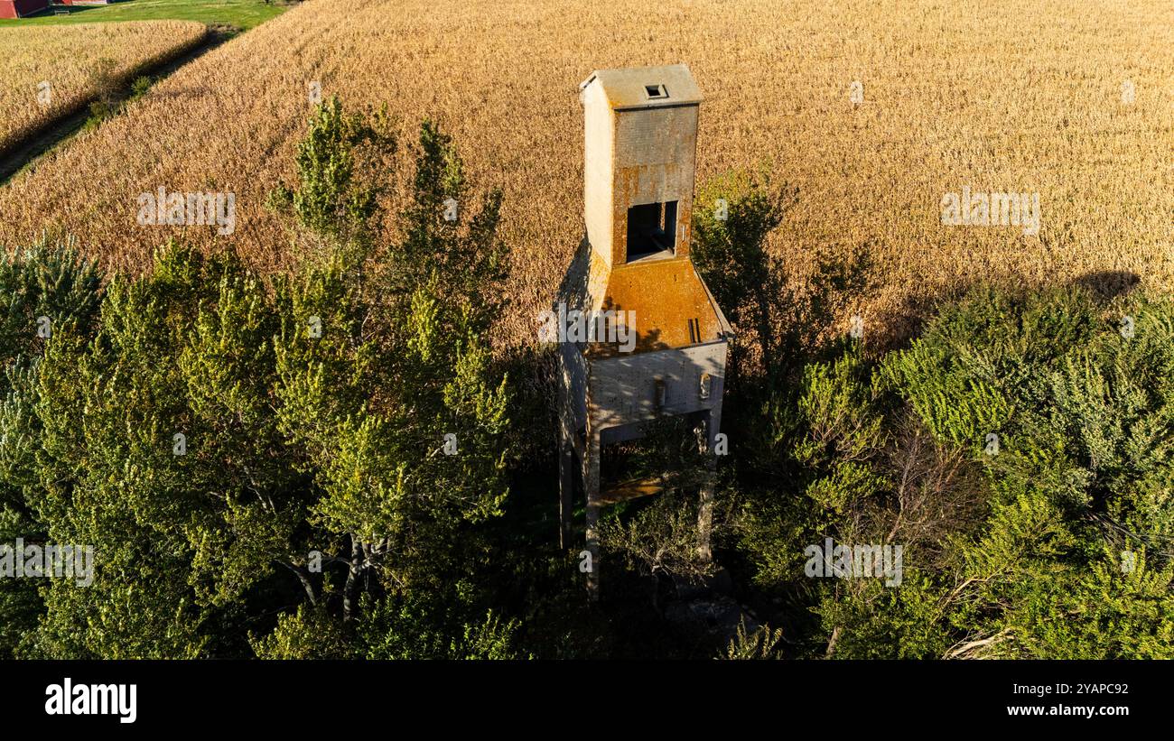 Aerial photograph of an abandoned grain elevator standing in a corn ...