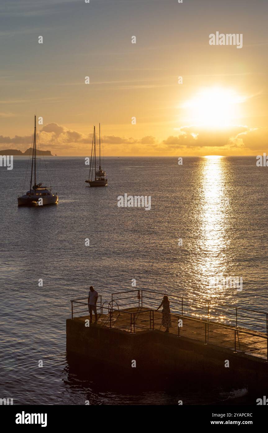Beautiful golden sunrise over yachts in the harbour at Machico , the ...