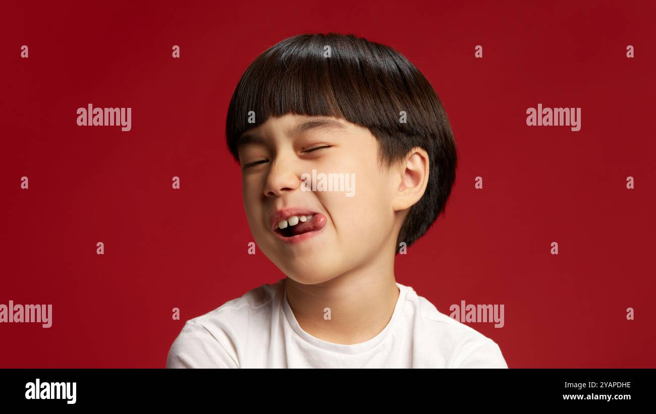 Cheeky smile sneaks out a child makes funny face, showing carefree and joyous side to childhood ...