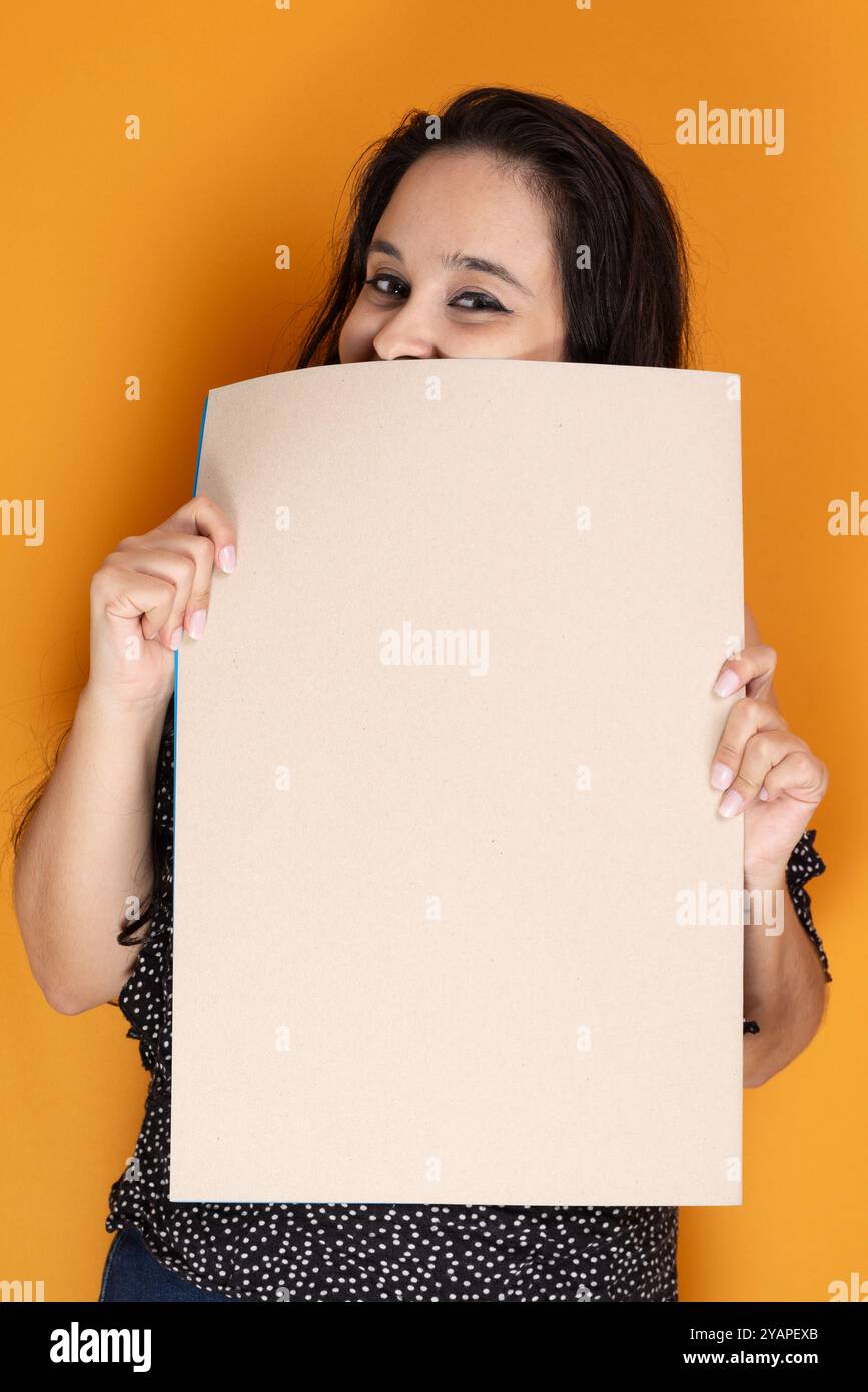 Beautiful black haired latin american woman holding blank banner ...