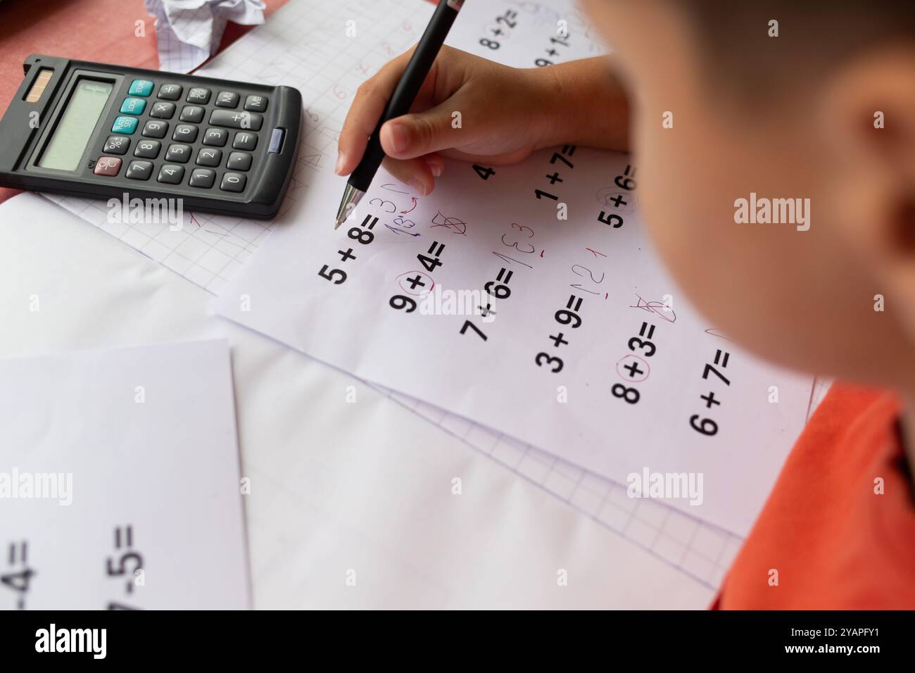 Over the shoulder view of a child who has dyslexia and dyscalculia ...