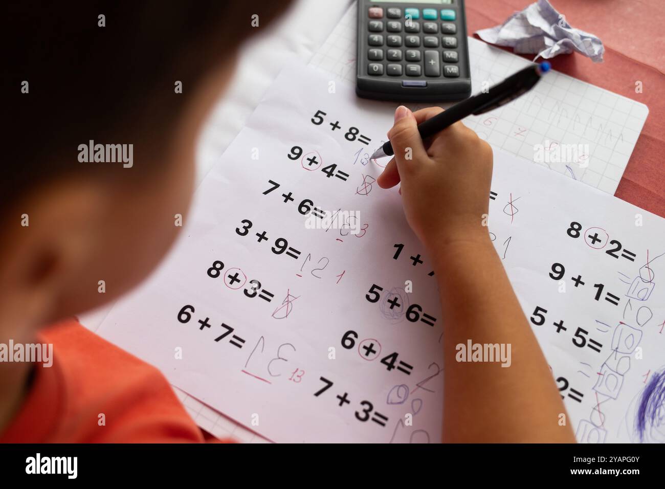 Over the shoulder view of a child who has dyslexia and dyscalculia ...