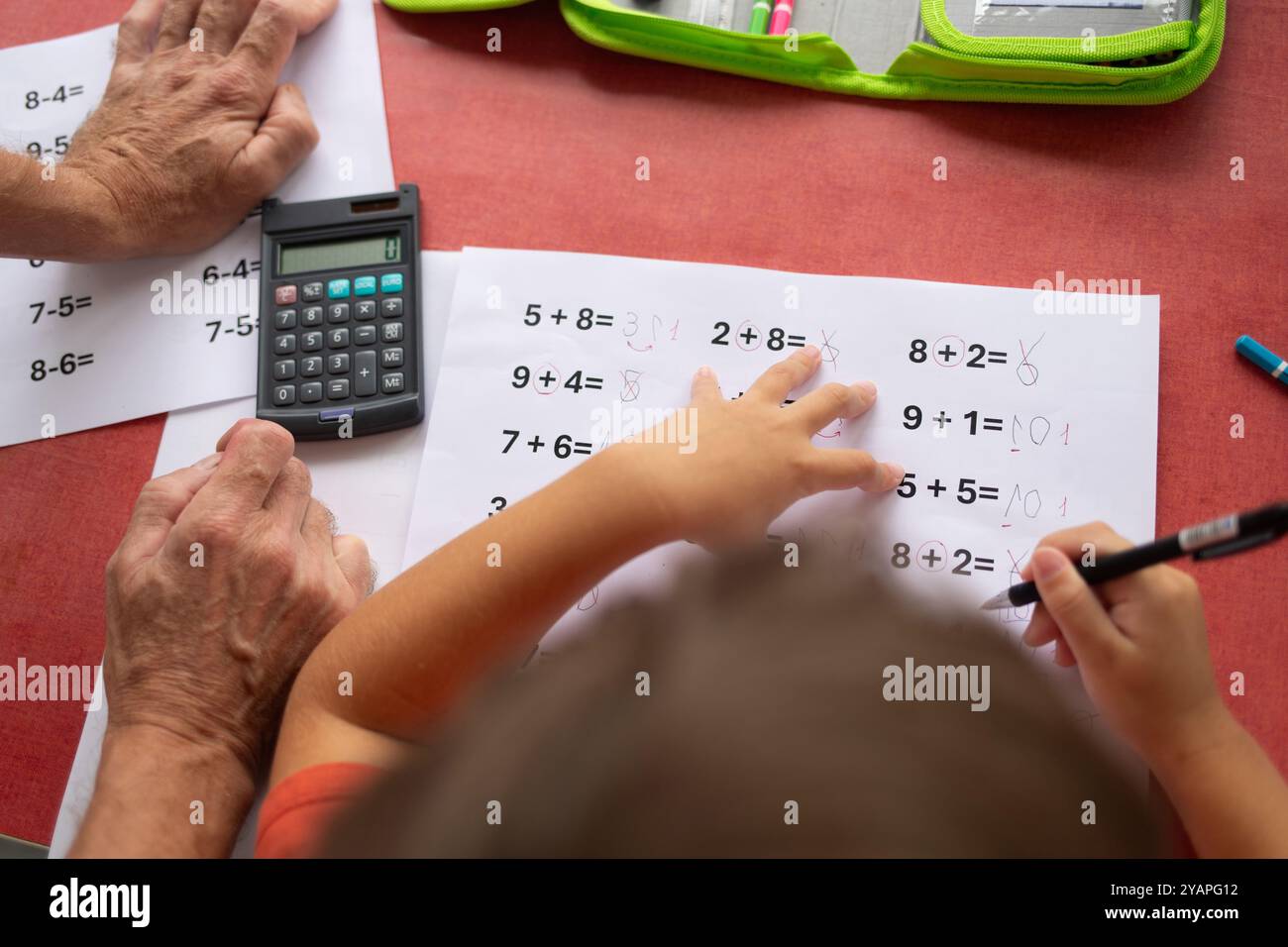 Over the shoulder view of a child who has dyslexia and dyscalculia ...