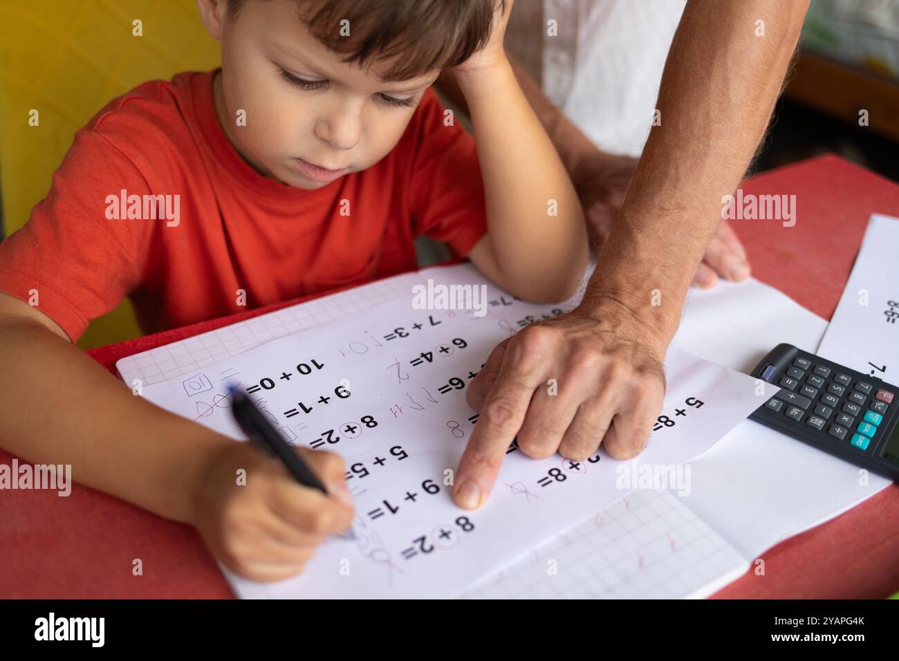 A boy with dyscalculia and dysgraphia tries to complete his math ...