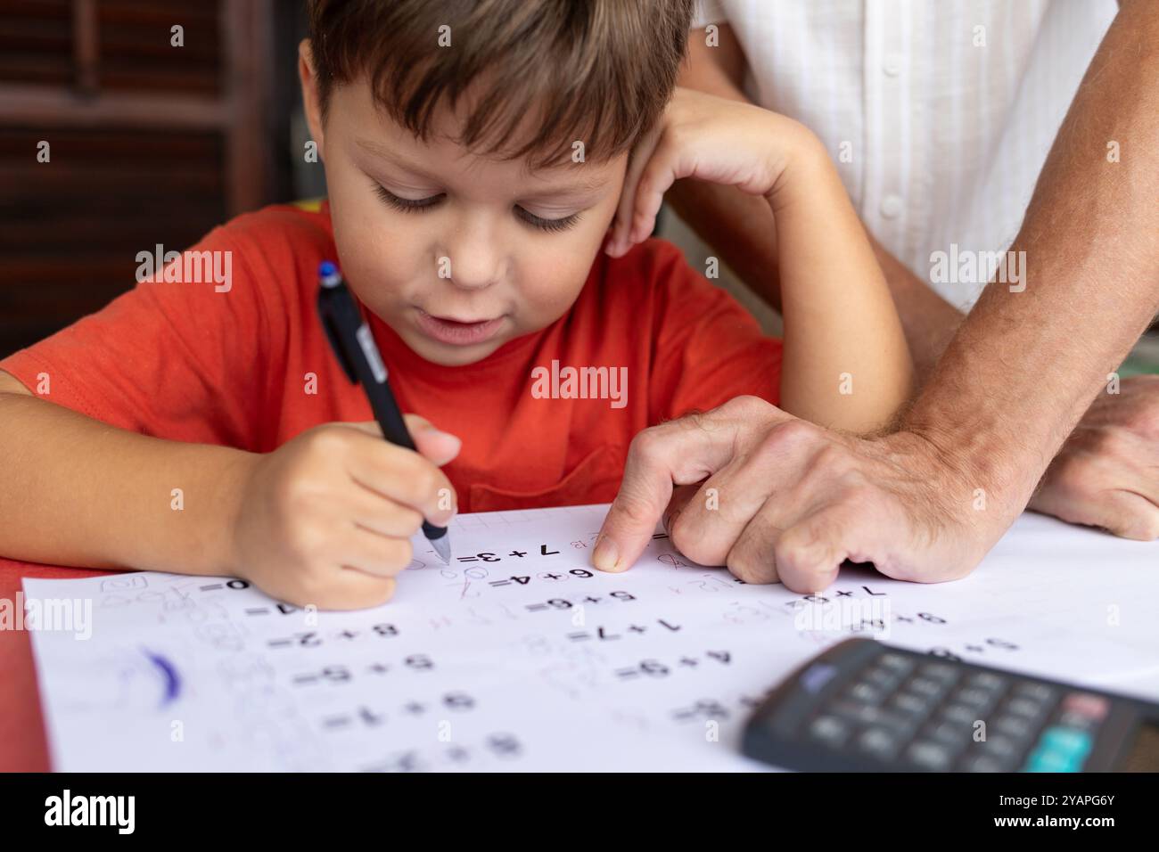 A six-year-old boy with dysgraphia and dyscalculia works on his math ...