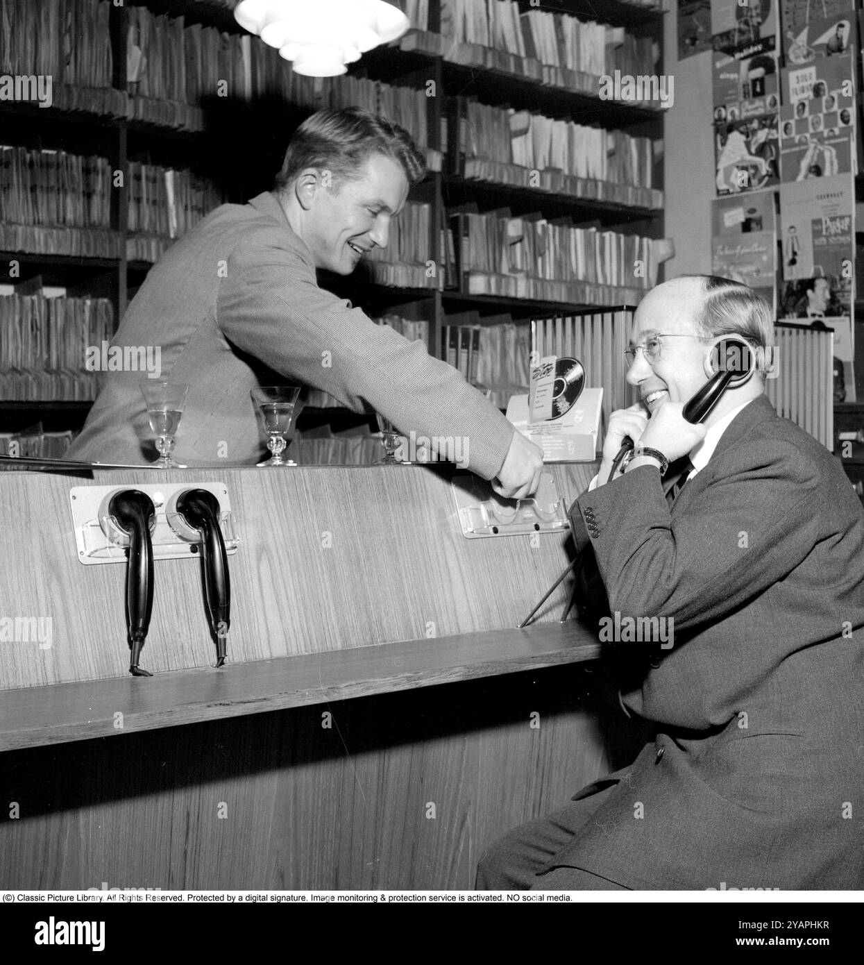 How you bought records in the 1950s. The man holding what looks like a ...