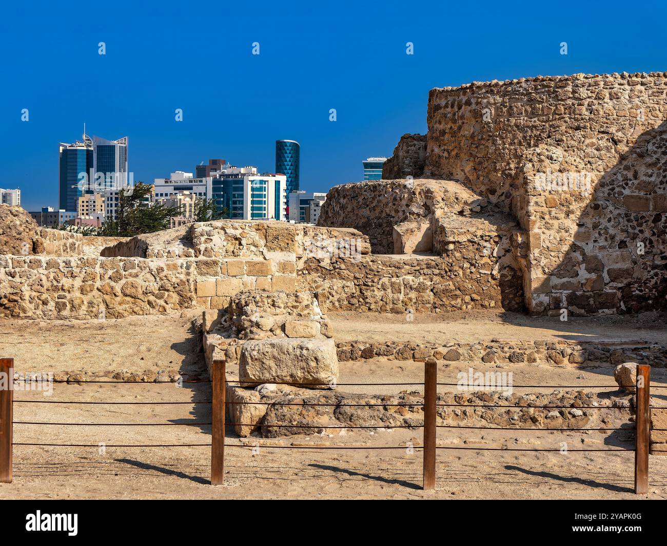 Ruins of the Bahrain Fortress Qal'at al-Bahrain and the skyline of ...