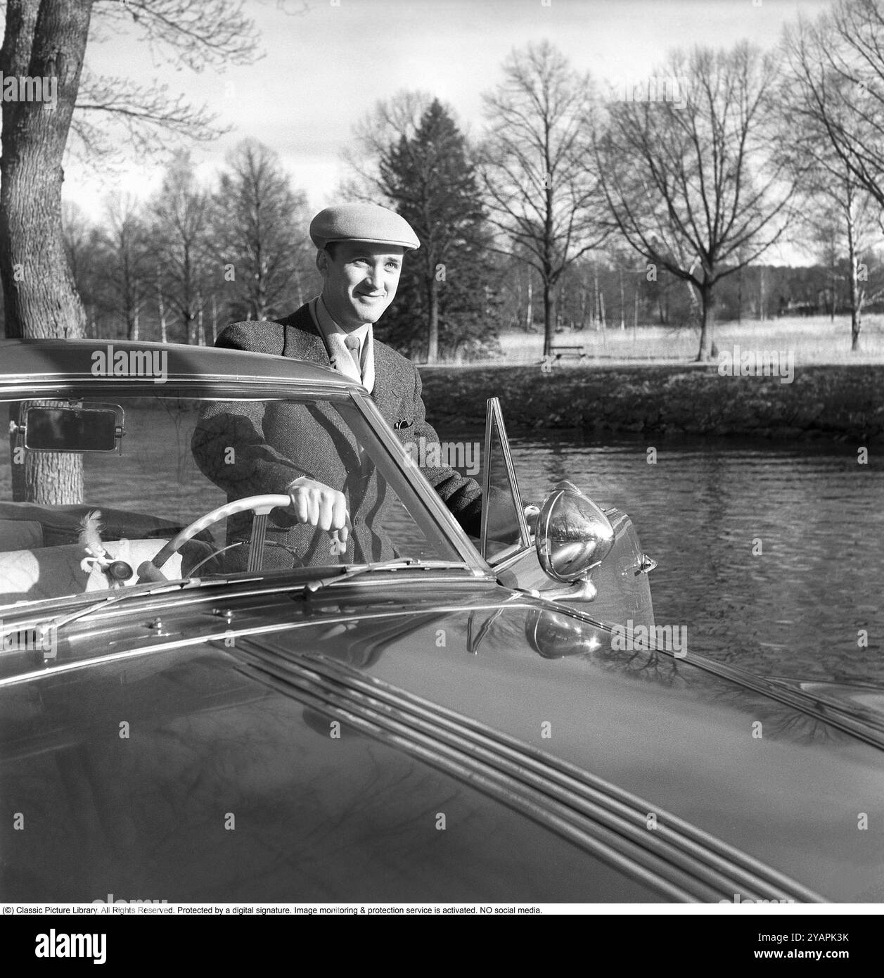 A proud car owner in the 1950s. A man in his car, a 1950 Austin A 90 ...