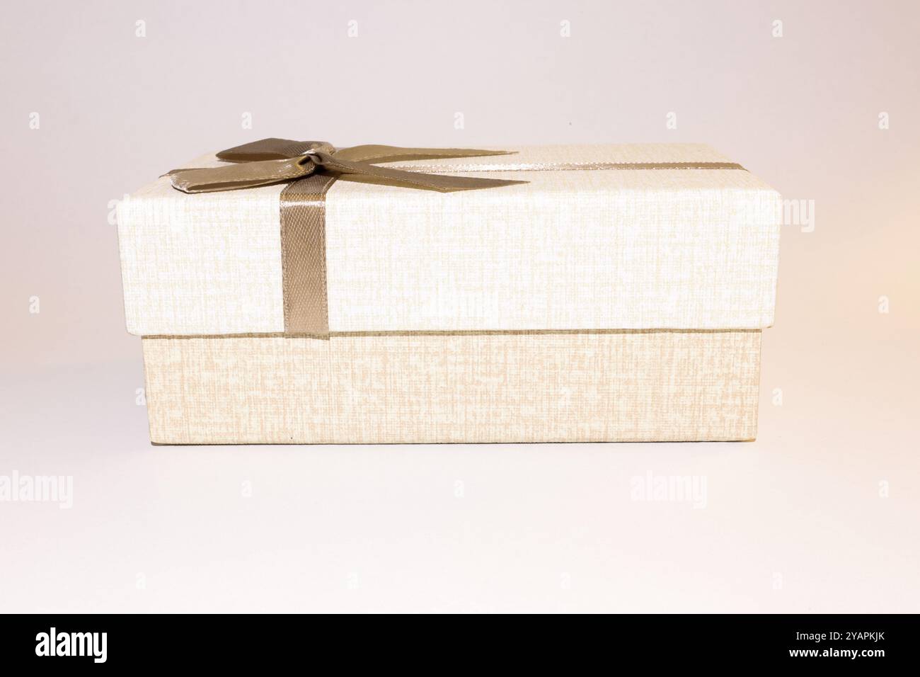 Beige gift box, with a brown bow, isolated on a white background Stock ...