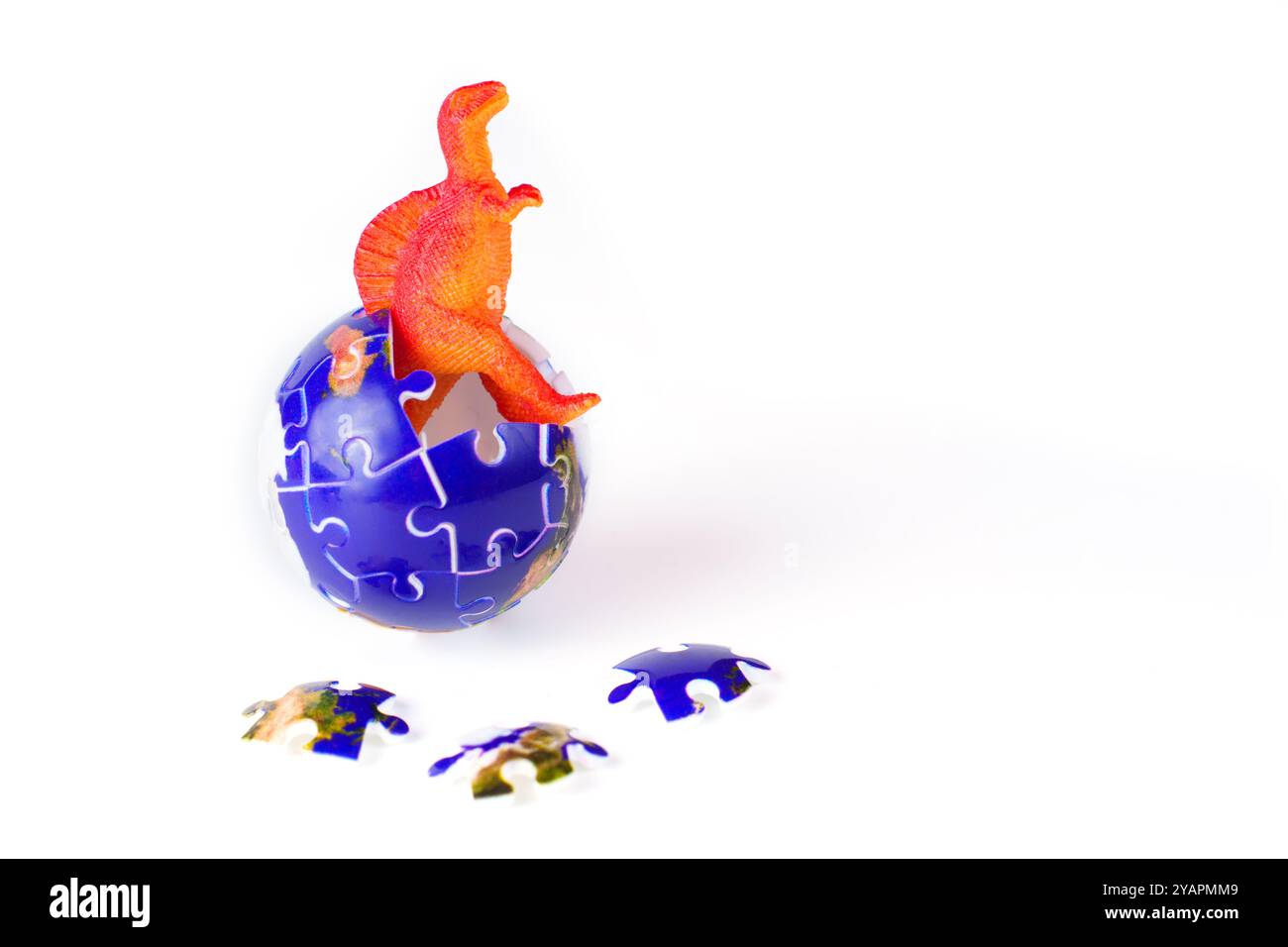 Orange dinosaur hatching from a puzzle globe with scattered pieces, set ...