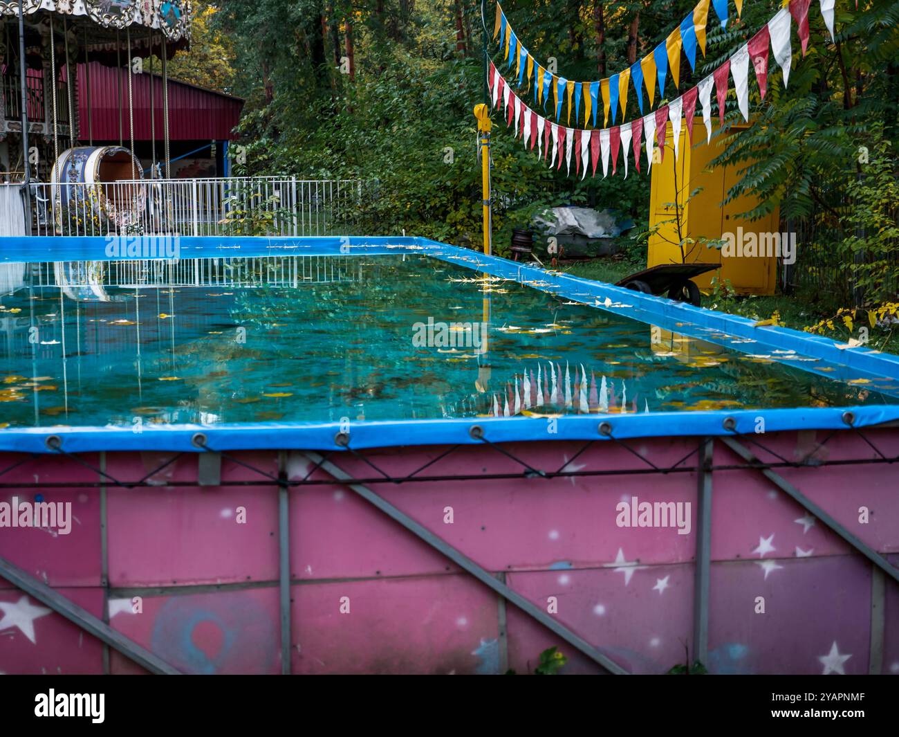 Empty moody swimming pool for the ride-on floating toys with fallen ...