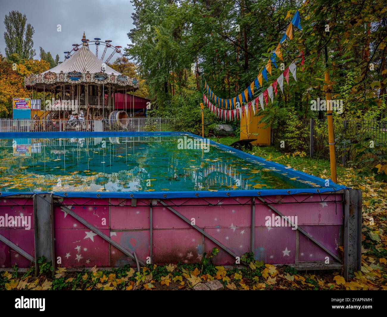 Empty moody swimming pool for the ride-on floating toys with fallen ...