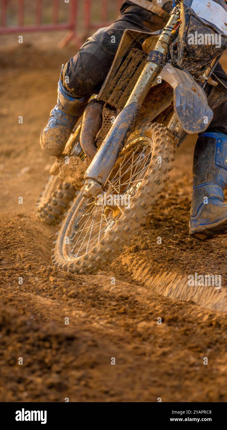 Detail of the front of an off-road motocross bike going around a curve ...