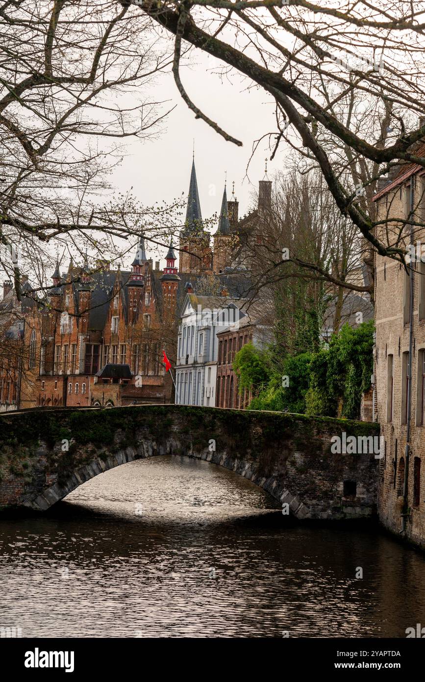 Brick spires and arched pedestrian bridges on the Groenerei Canal in ...