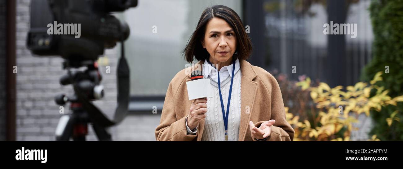 A confident journalist holds a microphone while delivering news updates ...