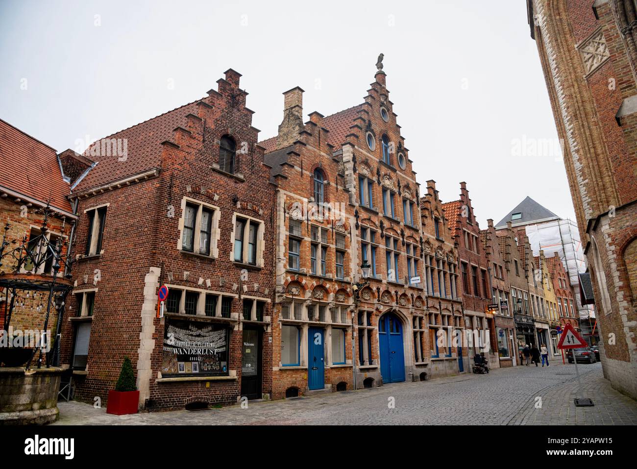 Cobblestone street and Flemish crow-stepped gables in medieval Bruges ...