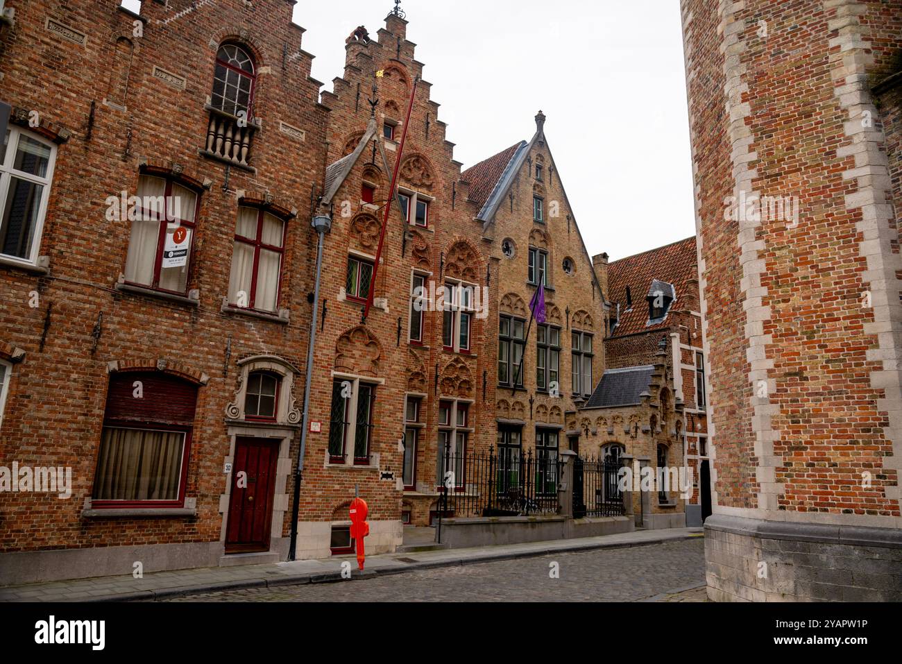 Gothic tracery and brick crow-stepped gable in Bruges, Belgium Stock ...