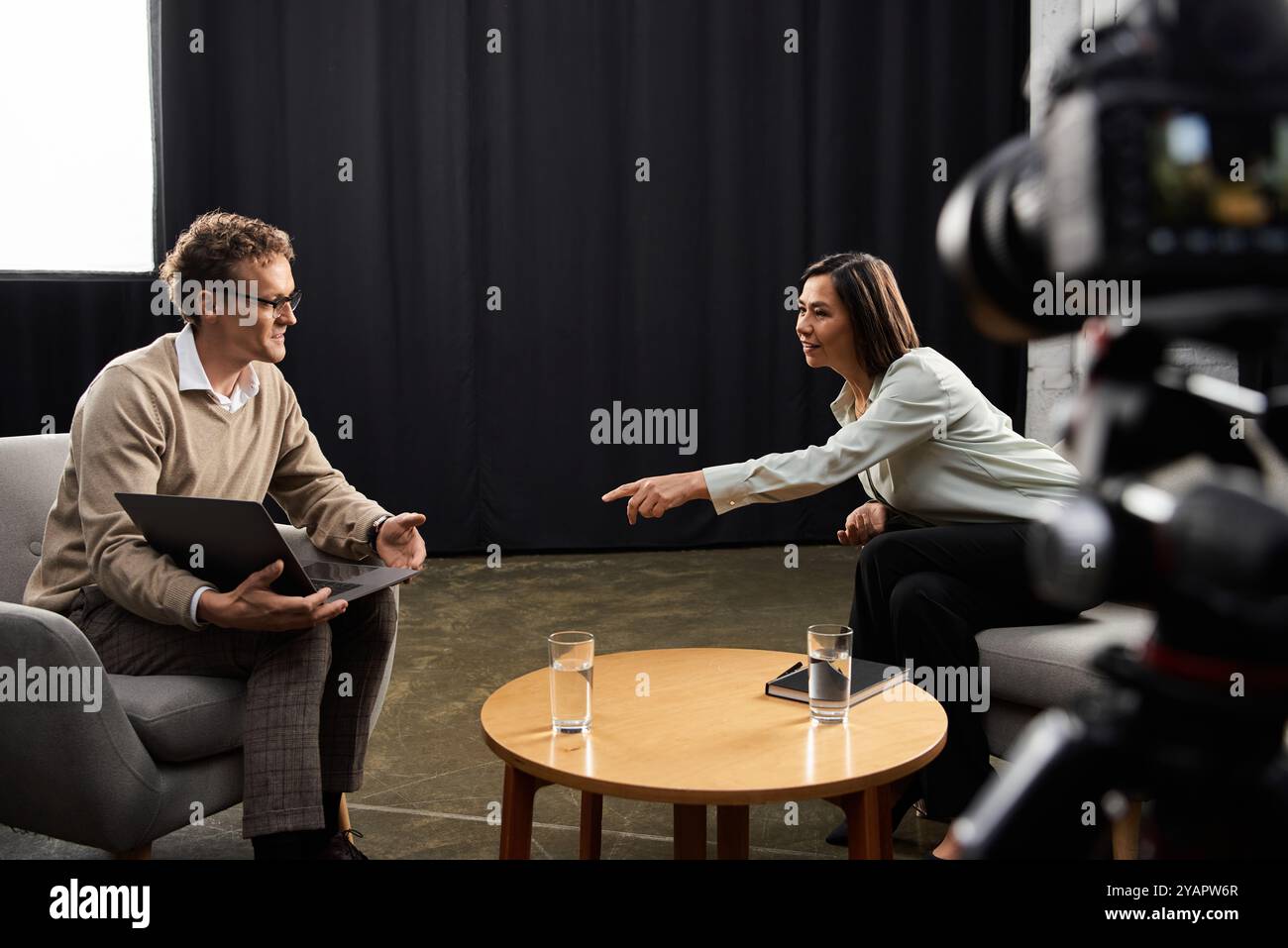 A middle-aged female journalist conducts an insightful interview with a specialist, showcasing ...