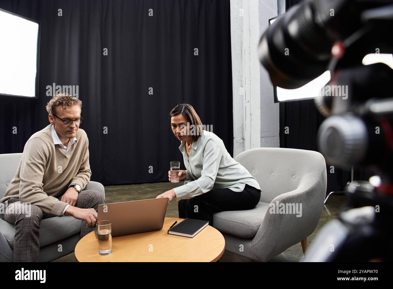 A middle-aged journalist engages with a specialist in a professional ...