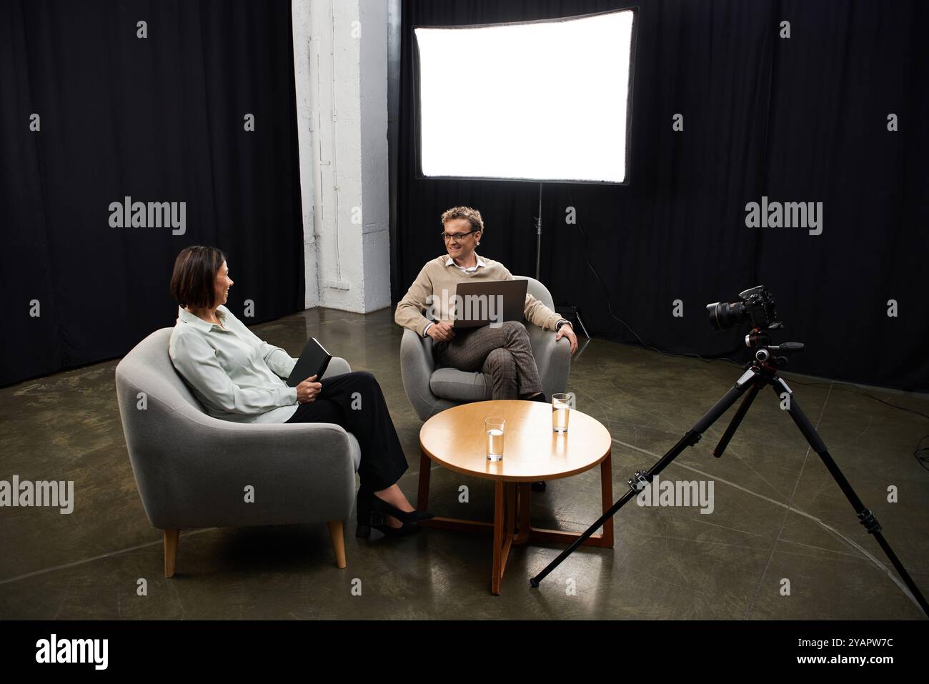 A middle-aged journalist engages in an insightful discussion with a ...