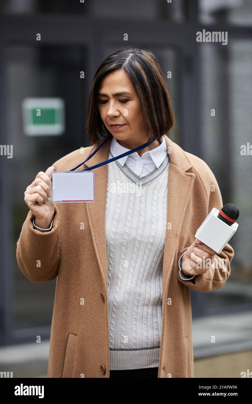 A multiracial female journalist stands outdoors, holding a microphone ...