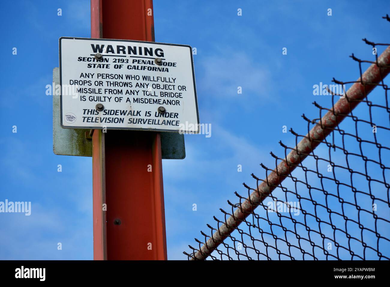 Warning sign on The Golden Gate Bridge under a blue sky Stock Photo - Alamy