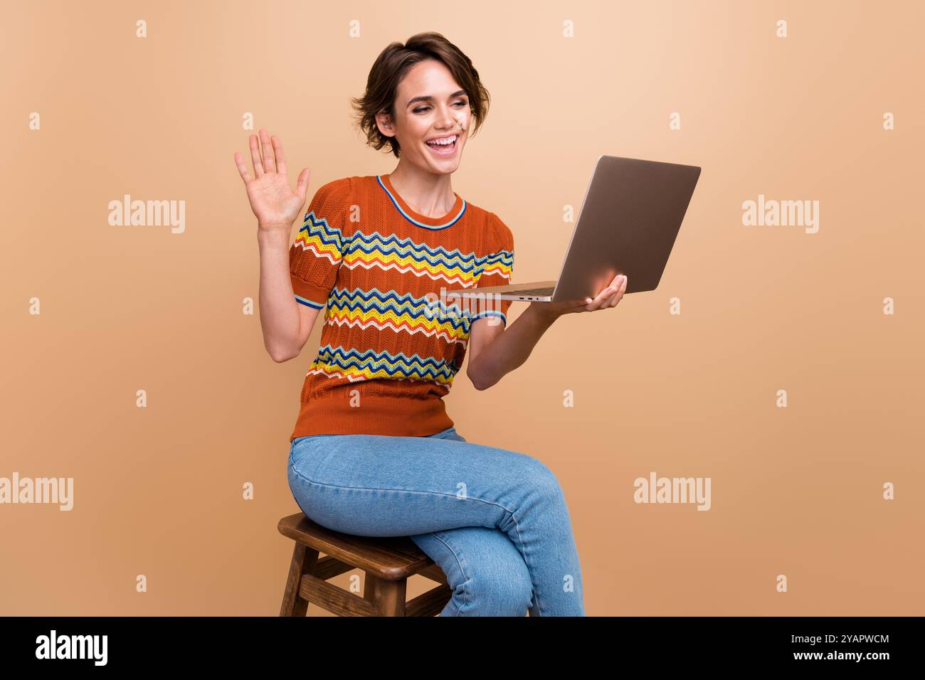 Full body photo of cheerful pretty lady sit chair arm palm waving hi ...