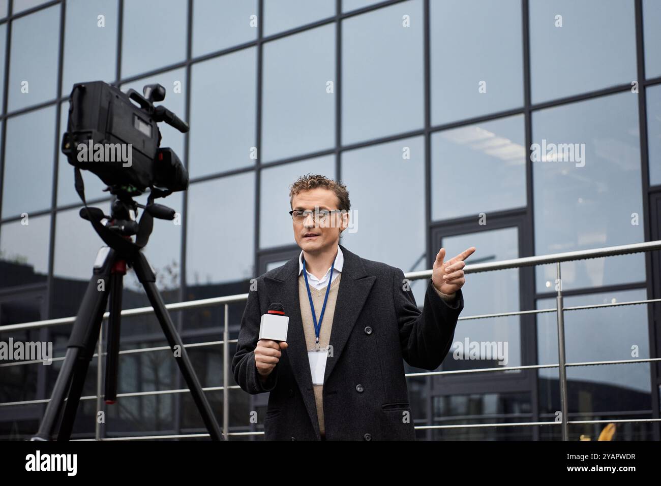 A professional journalist wearing glasses reports live, engaging with ...