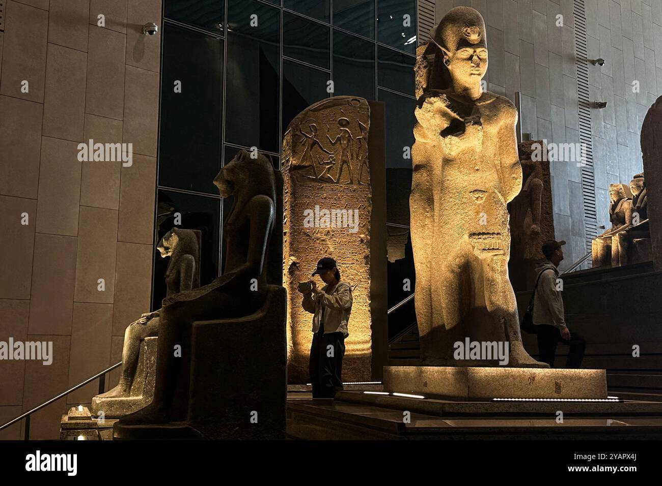 Giza, Egypt. 15th Oct, 2024. Visitors inspect ancient Egyptian statues ...