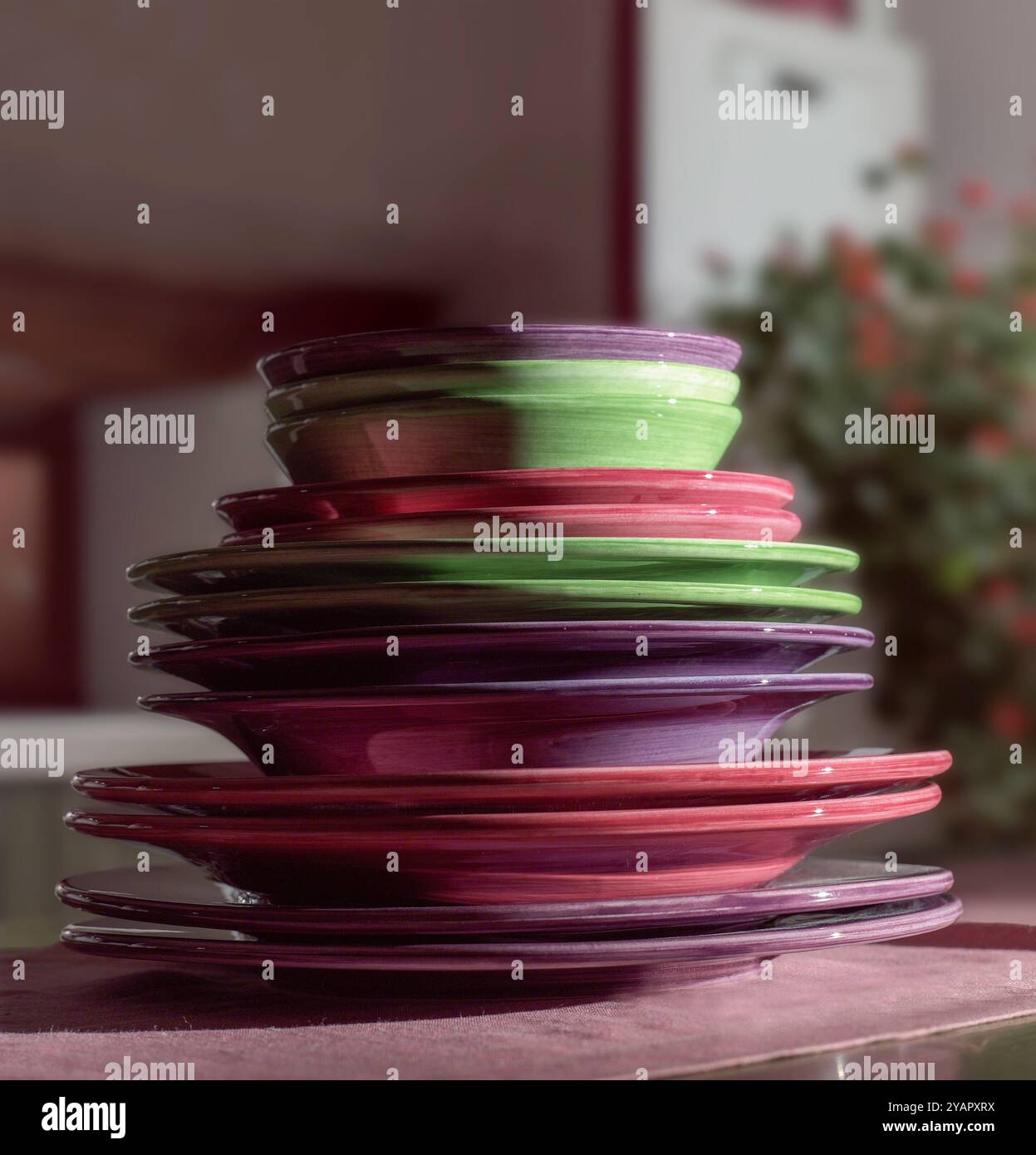 Still life of a stack of colorful plates Stock Photo - Alamy