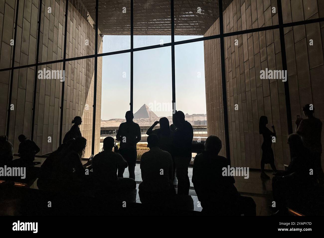Giza, Egypt. 15th Oct, 2024. Visitors stand by a window overlooking the ...