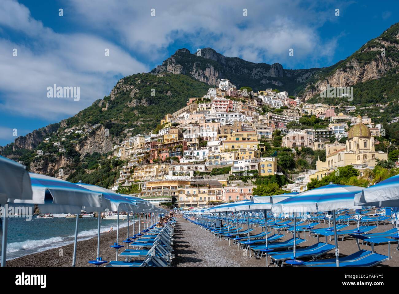 Nestled against dramatic cliffs, vibrant buildings of Positano create a ...