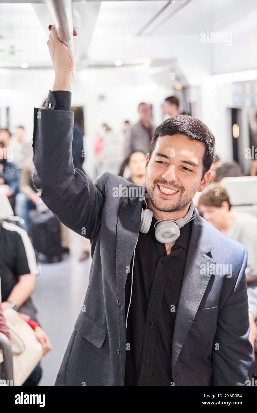 business man standing in the subway car. Man returning home after a day ...