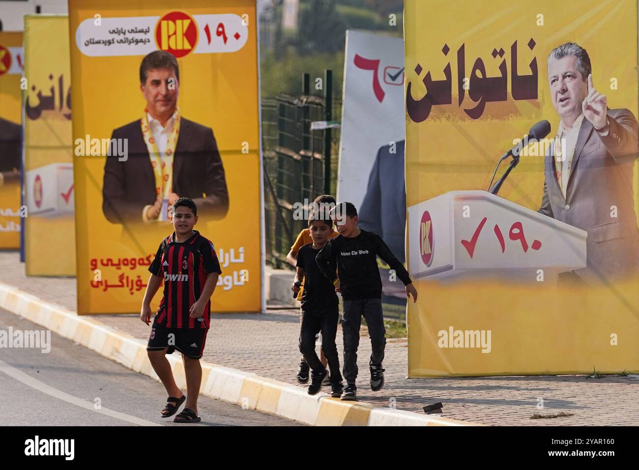 Duhok, Iraq. 13th Oct, 2024. kids seen walking past electoral banners ...