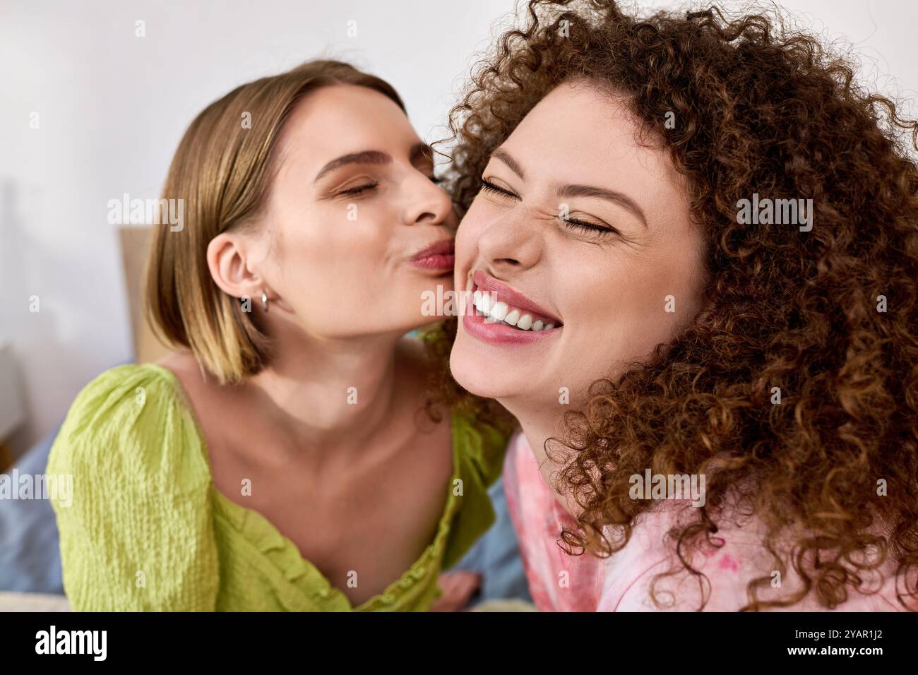 Two beautiful young women enjoying each other, radiating happiness and ...