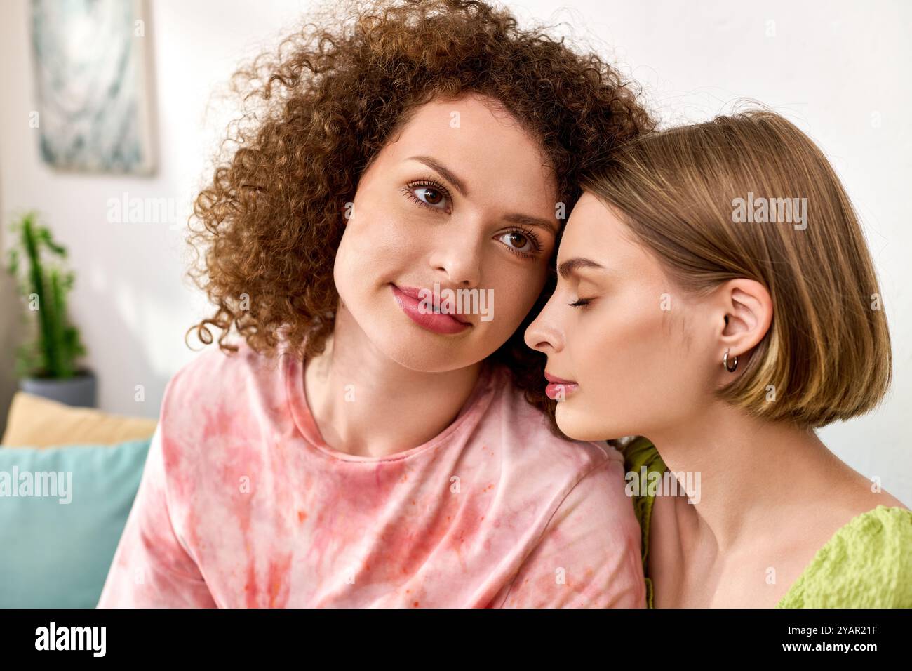 Two young women cuddle close, sharing warmth and affection in their ...