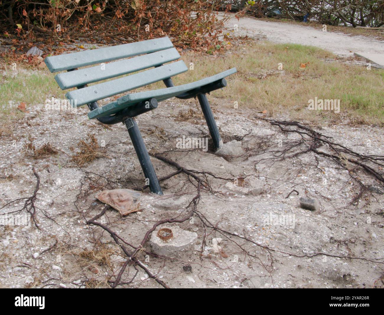Green park bench and concrete footers pulled out of the ground after ...