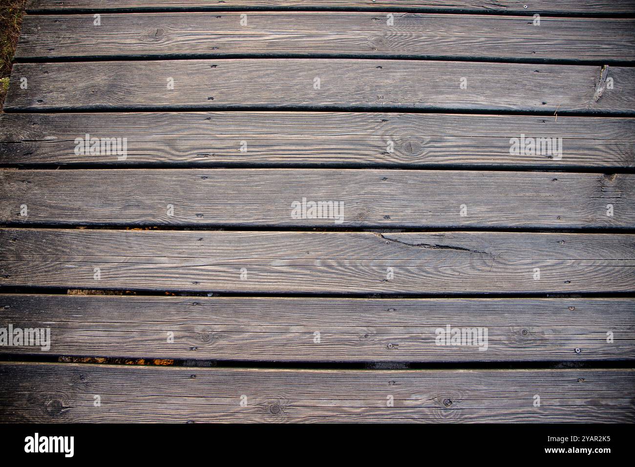 Close-up view of a weathered wooden deck, showcasing the natural grain ...
