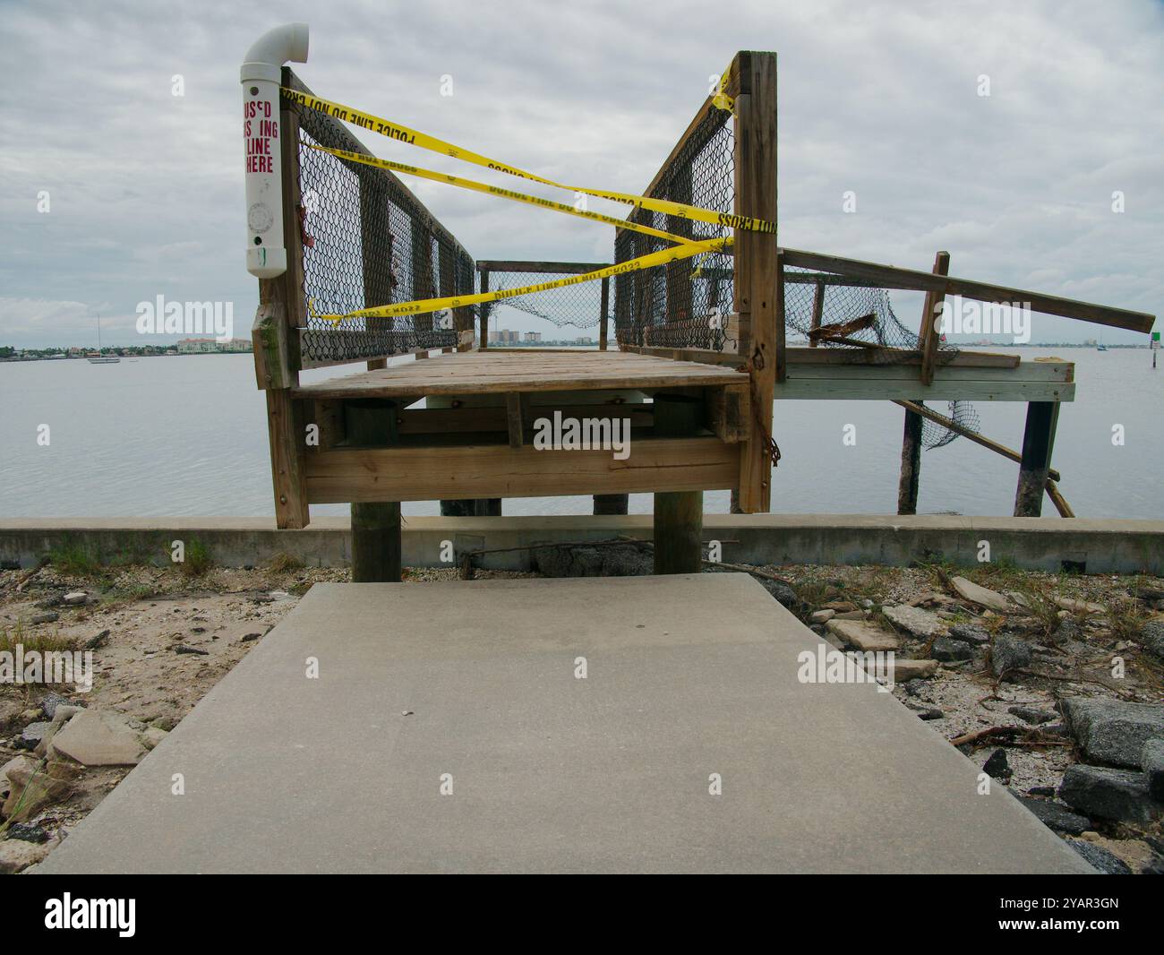 Front POV leading lines yellow tape warning view damaged Wooden Beach ...