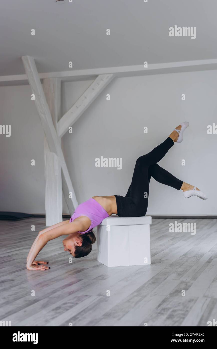 Girl gymnast doing difficult exercise for balance and strength on ...