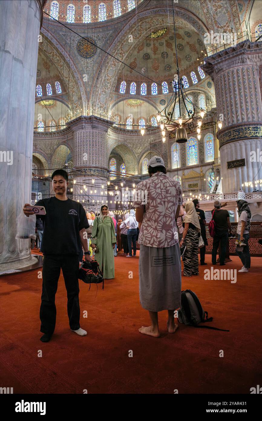 Tourists taking photographs in the Blue Mosque, Istanbul, Turkey Stock ...