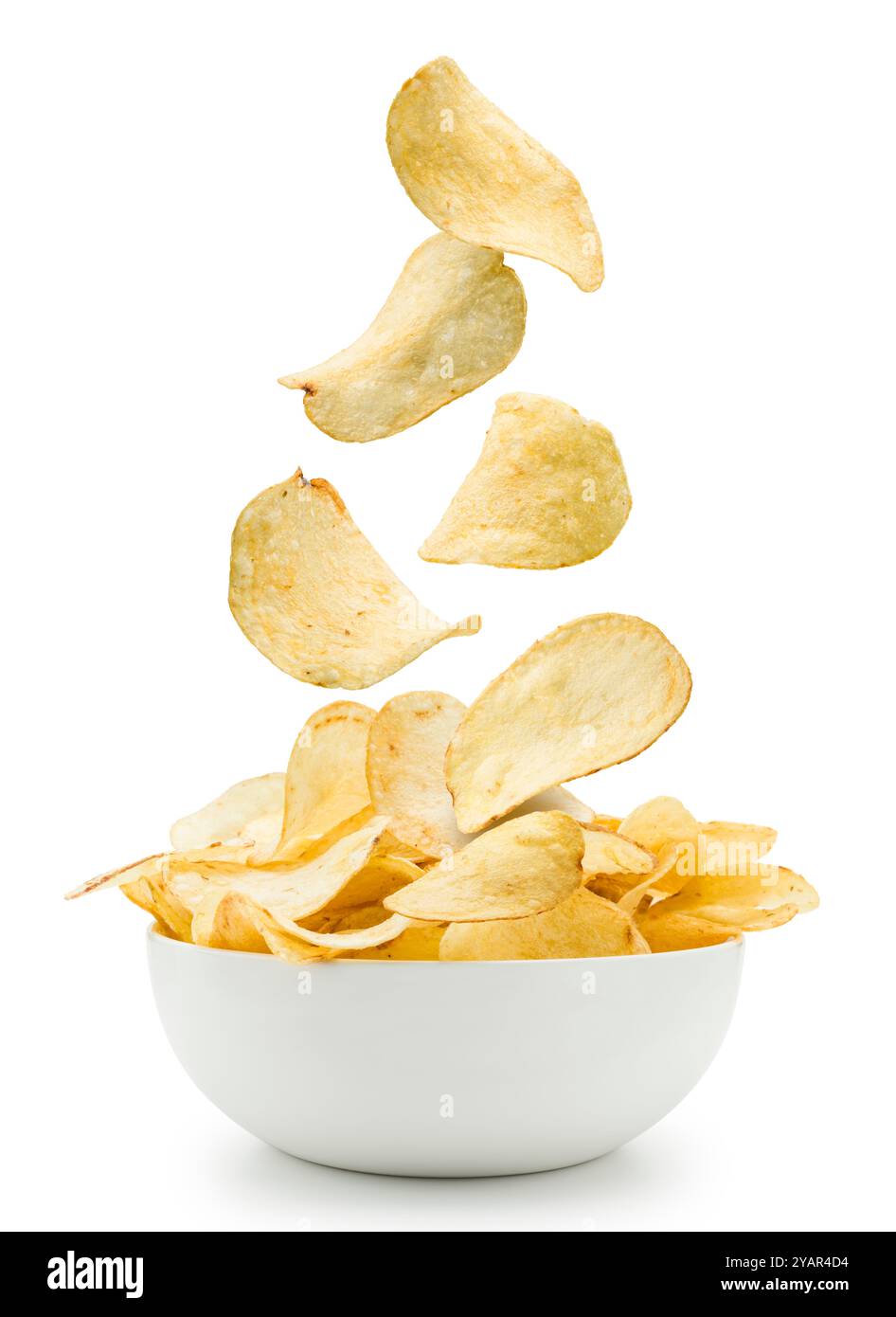 Potato chips falling into white bowl on white background Stock Photo ...