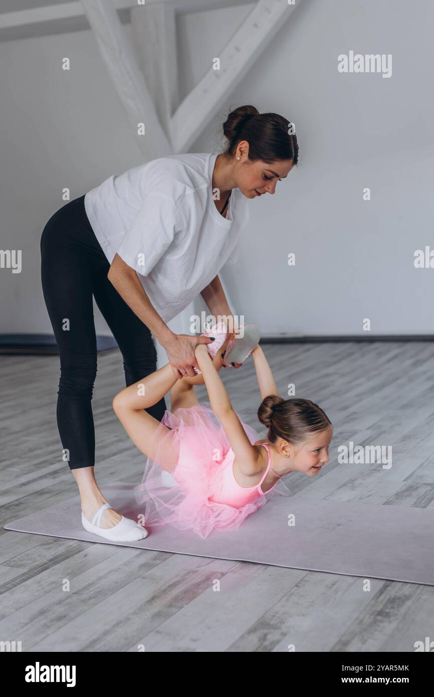 Baby ballet studio. Little ballerina with a coach in dance class ...