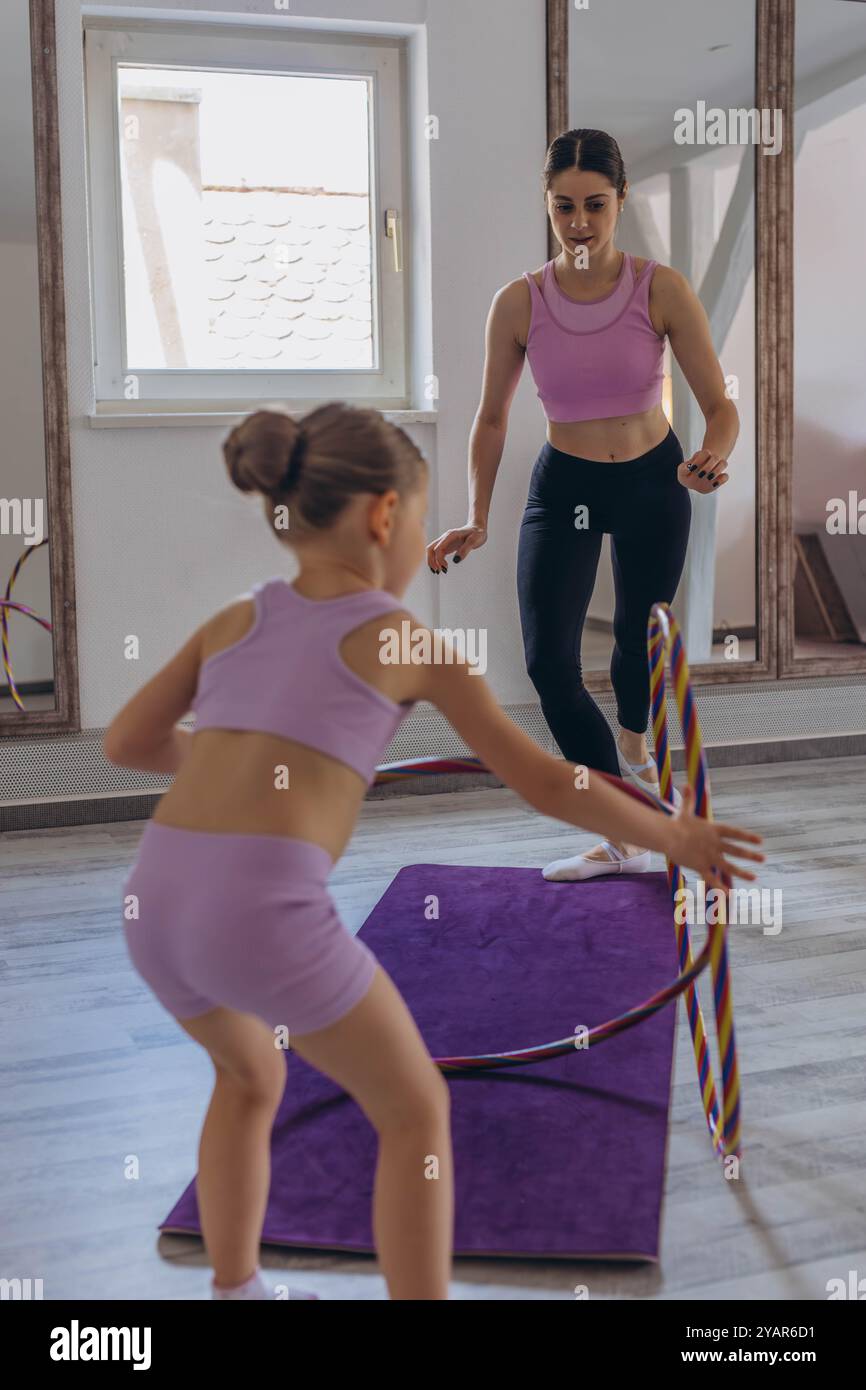 GymnasGymnast child performs an exercise with hoop.Children's ...
