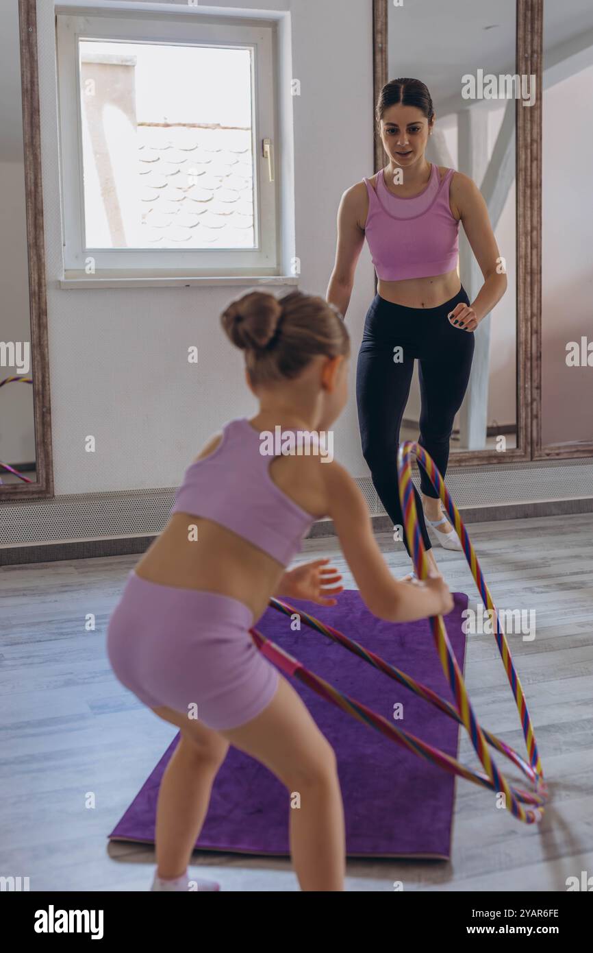 GymnasGymnast child performs an exercise with hoop.Children's ...