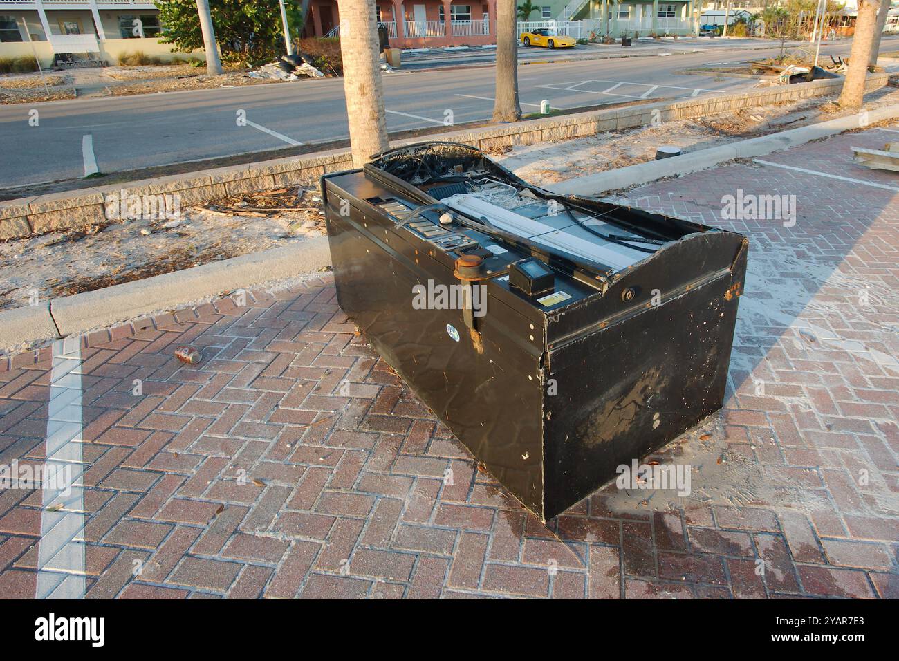 Black Vending machine tipped on its backside. Rusty bottom and ...