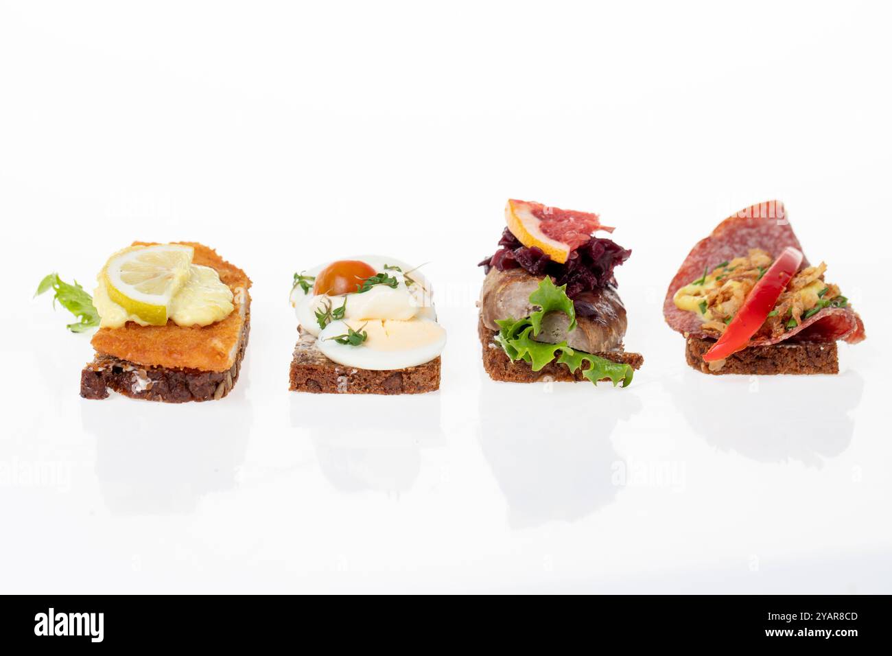 selection of open-faced Danish sandwiches (Smørrebrød) on dark rye ...