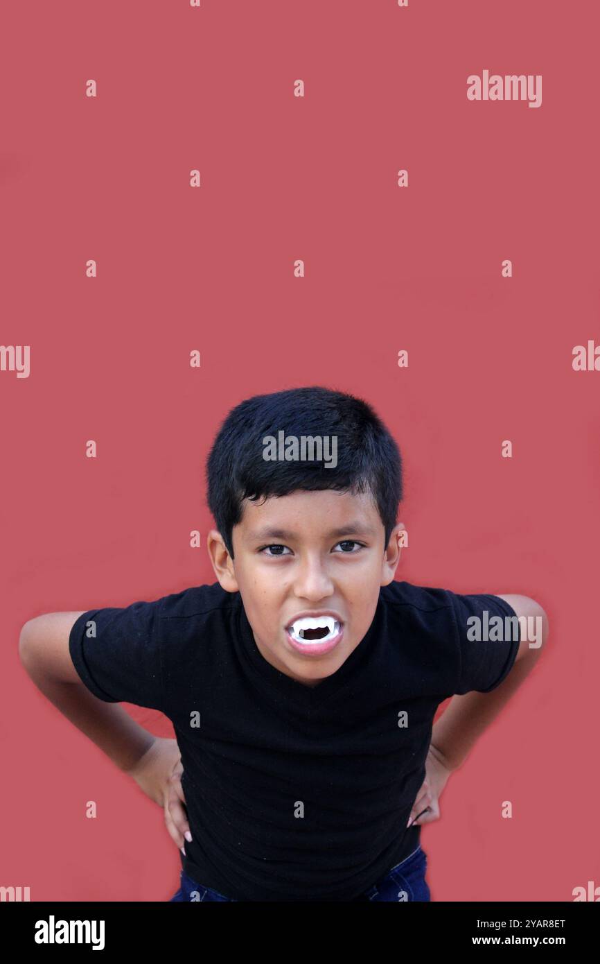 9-year-old dark-skinned Latino boy uses false vampire teeth to scare ...