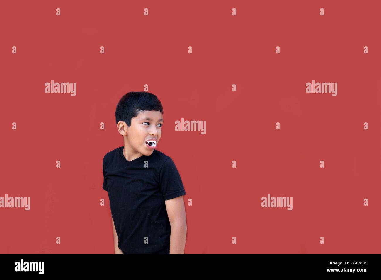 9-year-old dark-skinned Latino boy uses false vampire teeth to scare ...